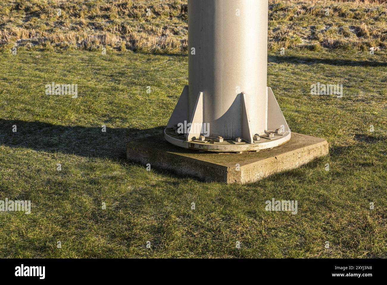 Base of a large metal pole bolted to a concrete foundation Stock Photo ...
