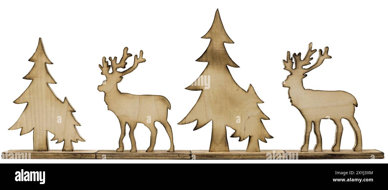 Deer figure sawn out of wood with dark edges and wooden fir trees cut ...