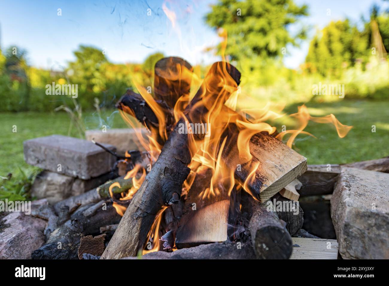 Campfire in a fireplace surrounded by stones Stock Photo - Alamy