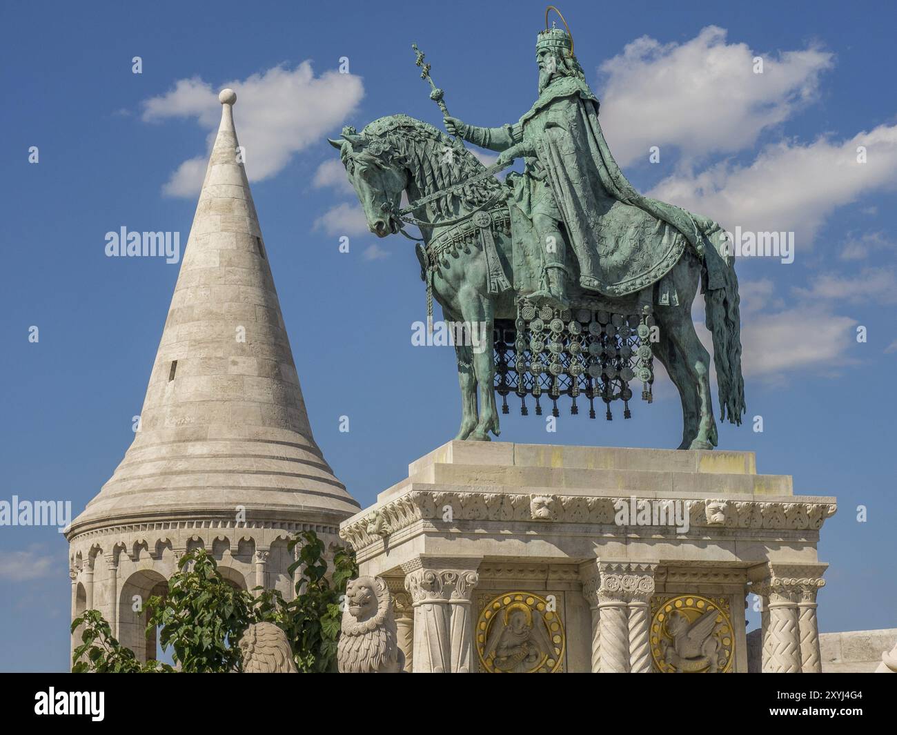 Equestrian statue in front of a historic building with a clear blue sky ...