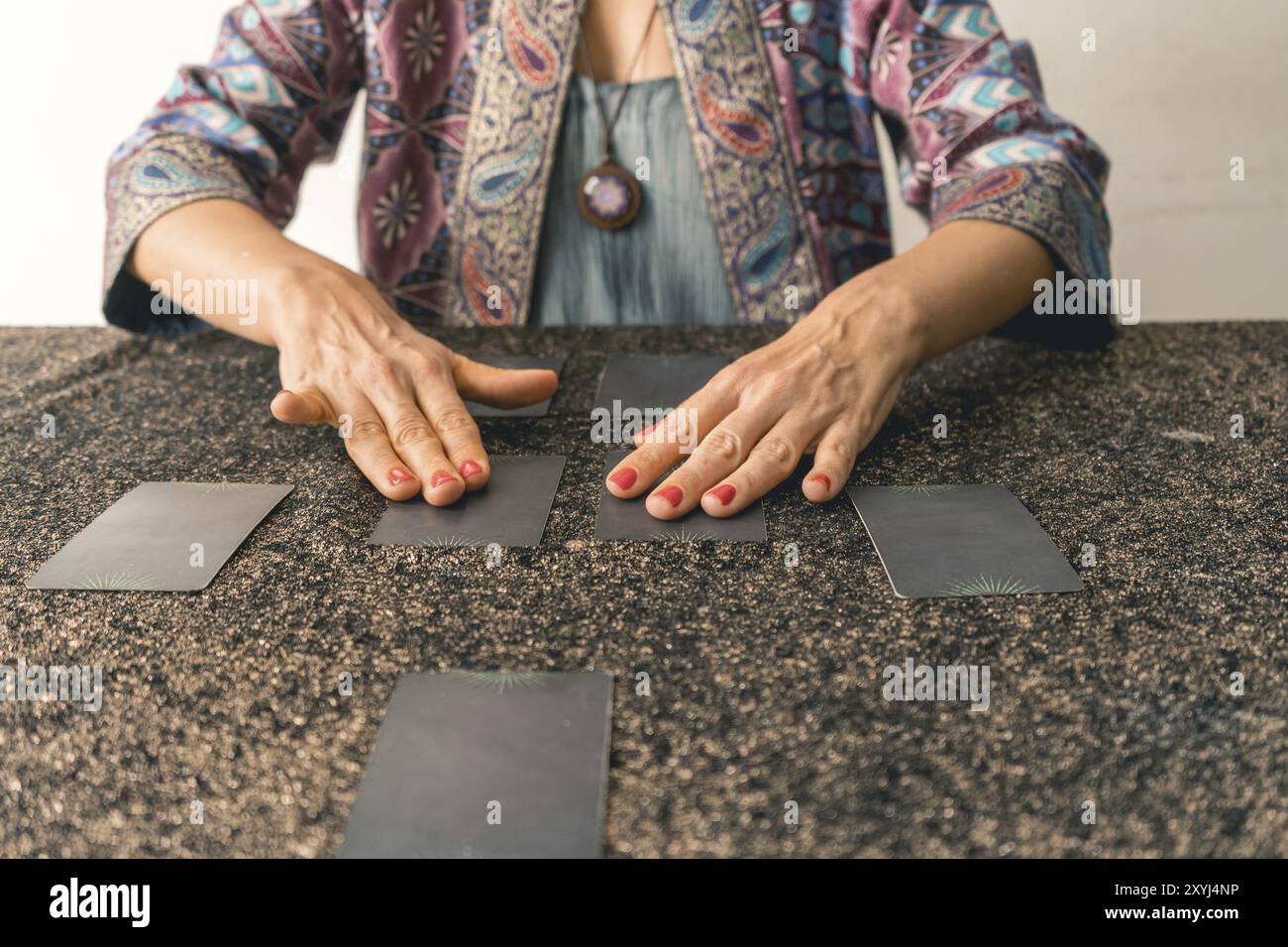 Engaging tarot reader ready to give a tarot reading, holding cards ...