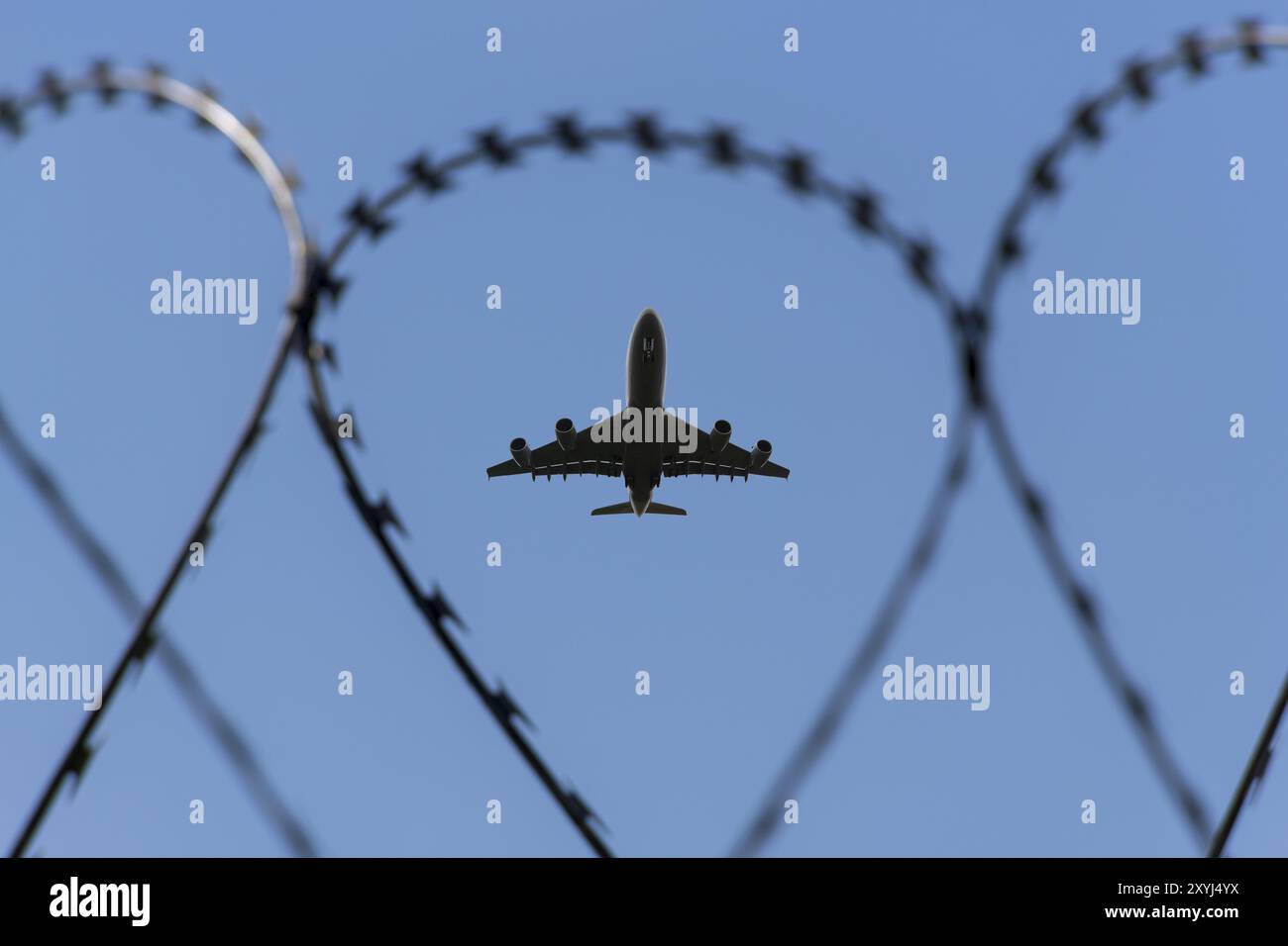 Symbolic image security, passenger aircraft taking off, security fence ...