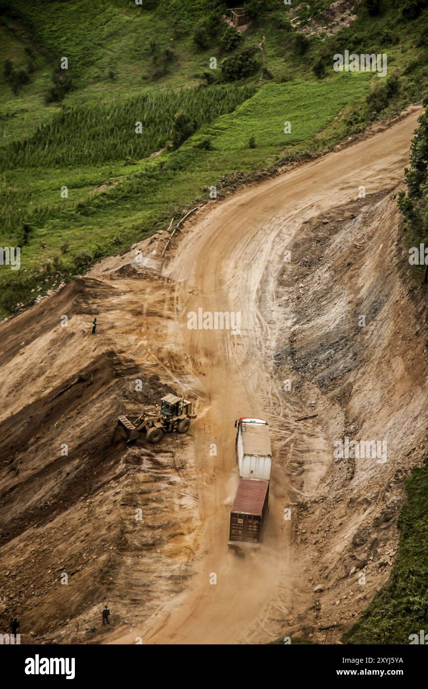 A large truck pulling a trailer with container of cargo is about to ...