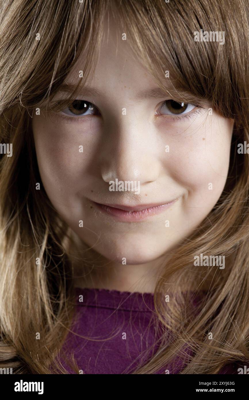 Portrait of a little girl in a purple jumper Stock Photo - Alamy