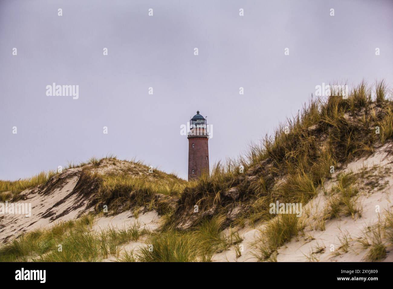 Red lighthouse in cloudy weather Stock Photo - Alamy