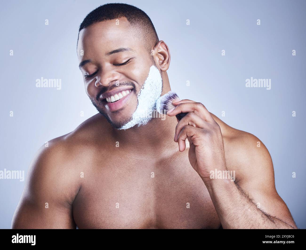 Black man, brush and apply shaving foam in studio, beauty and grooming routine for hair removal ...