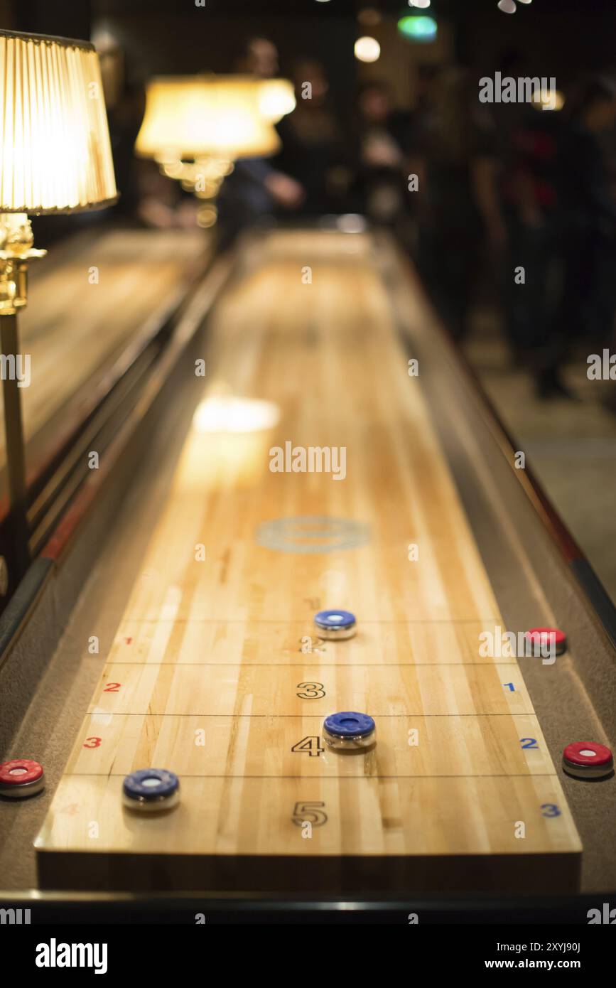 Playing the game of shuffleboard Stock Photo - Alamy
