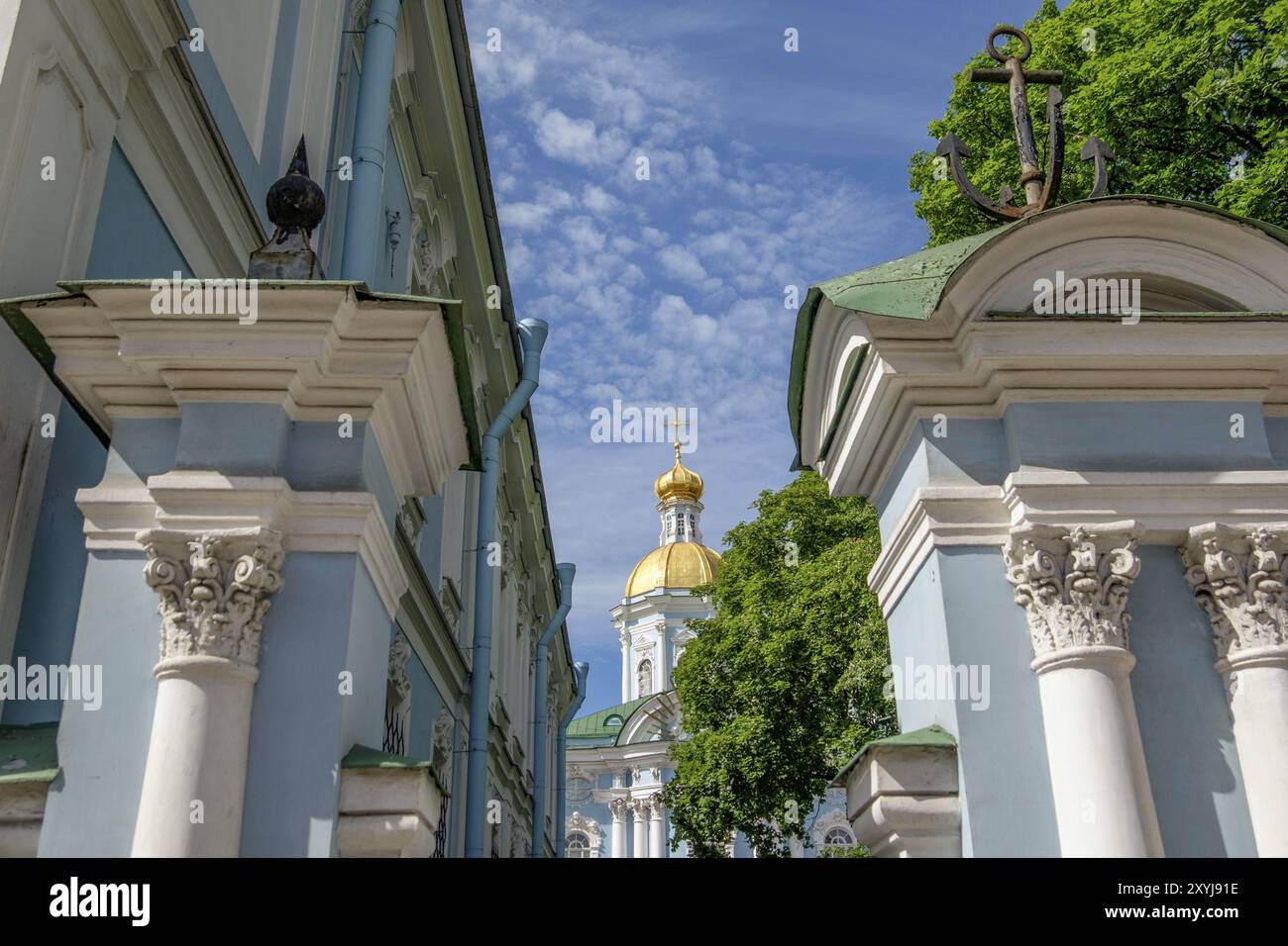 View of a church with golden dome through imposing columns and blue ...