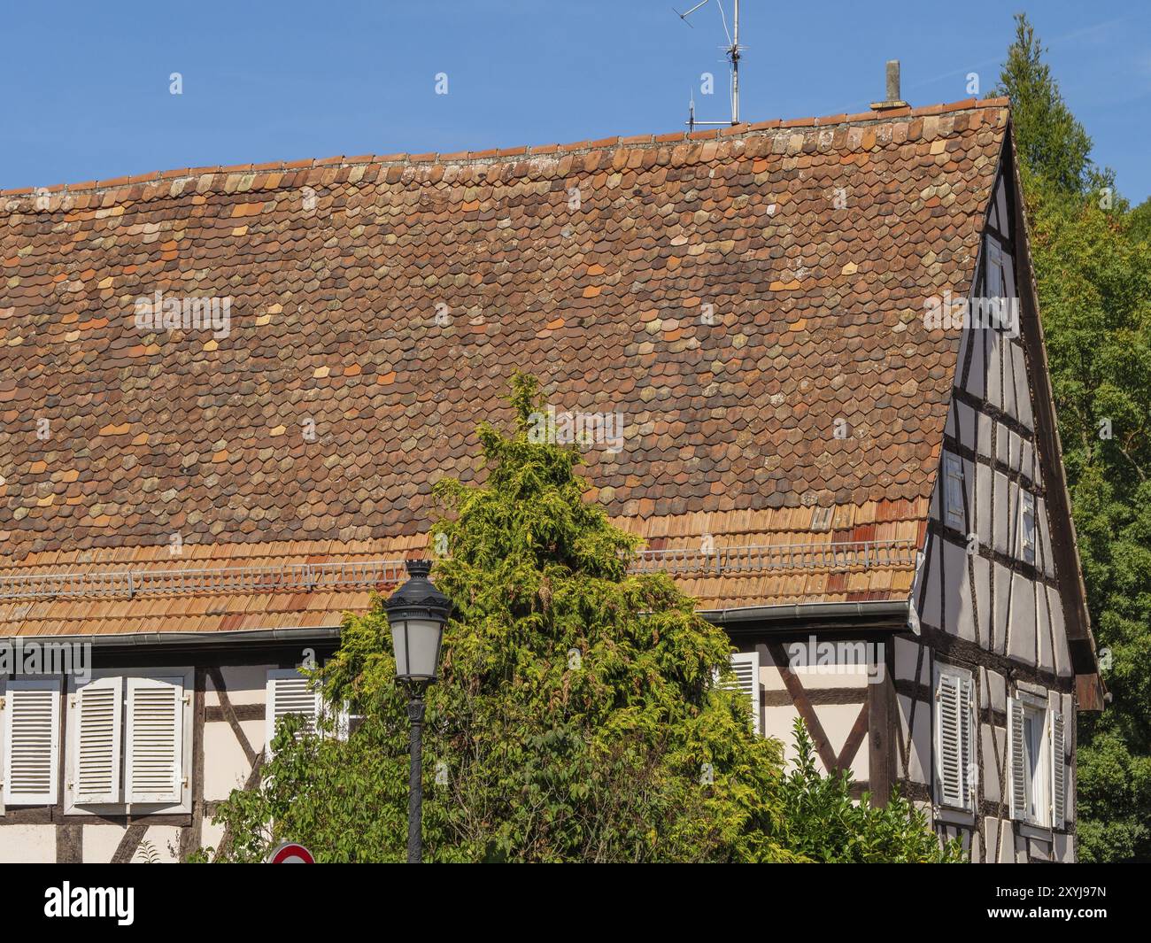 Traditional half-timbered house with historic roof tiles and lantern ...