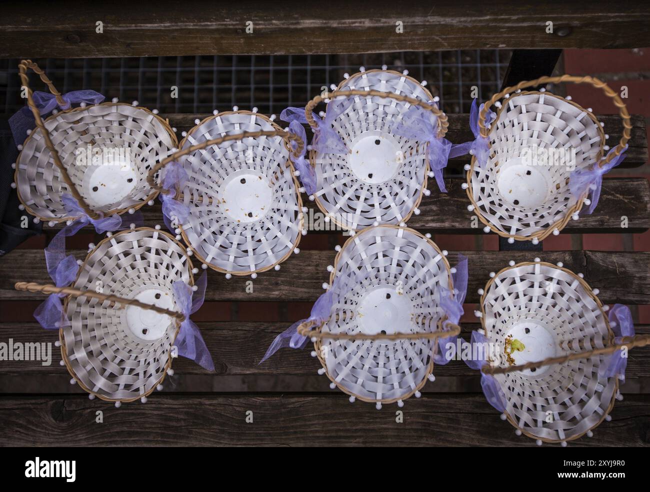 Small white wicker baskets with white ribbons stand on a bench Stock ...