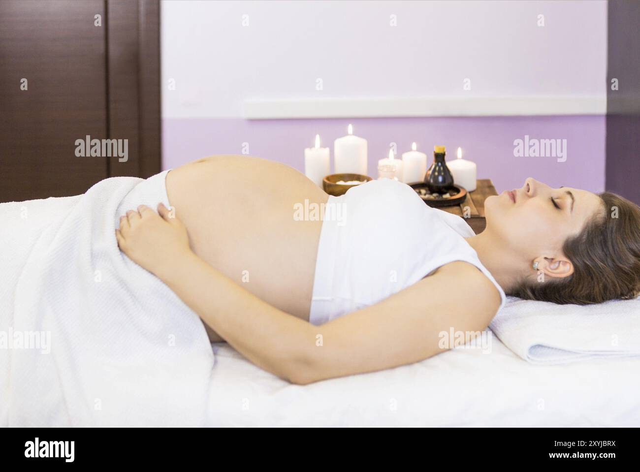 Young pregnant woman have massage treatment at spa salon Stock Photo - Alamy