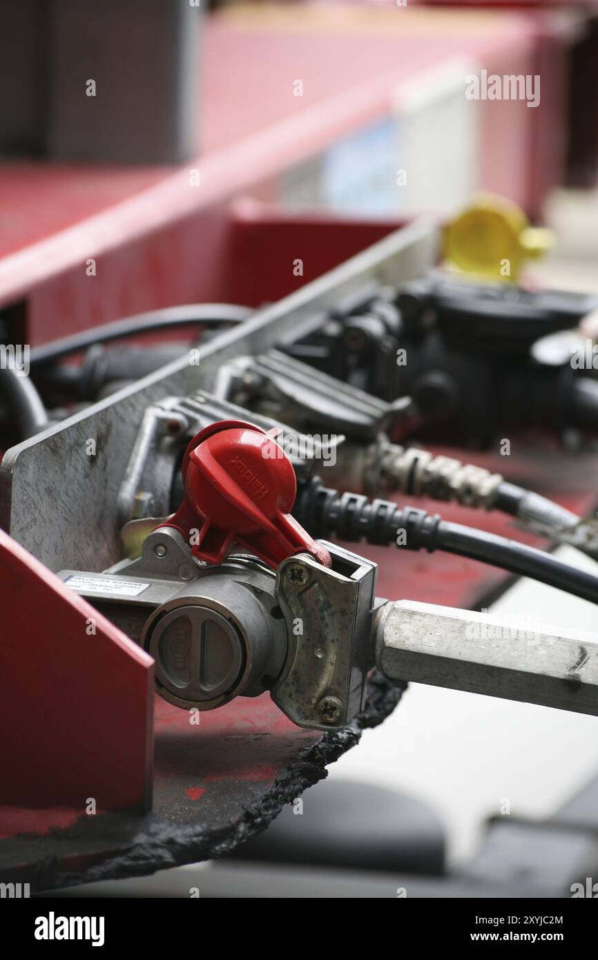 Connecting cables and plugs on a lorry between tractor unit and trailer ...