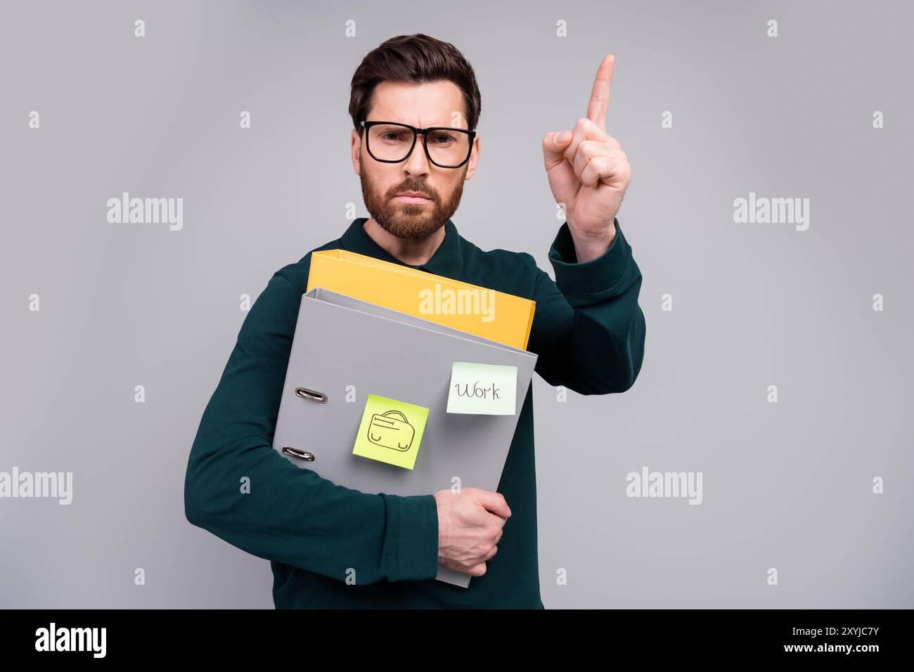 Photo of serious strict man wear trendy clothes hold folder finger up ...