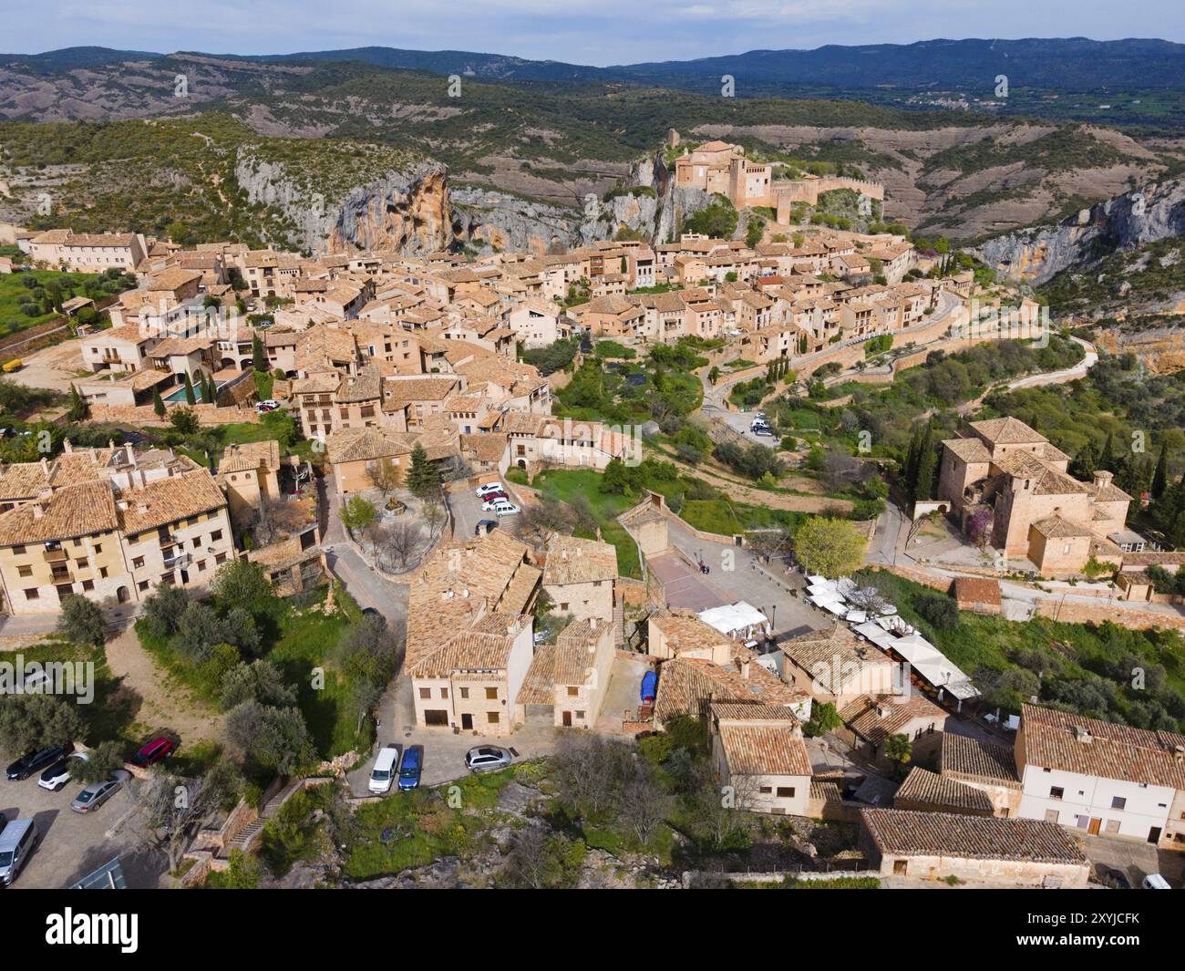 A charming village with historic tiled roofs and fortified buildings ...