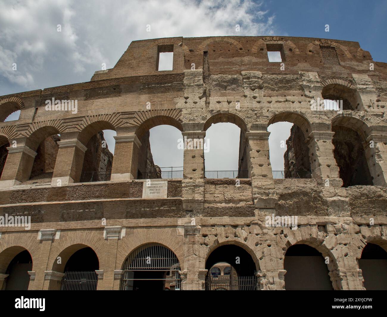 Side view of the Colosseum with arches and textured walls, Rome, Italy ...