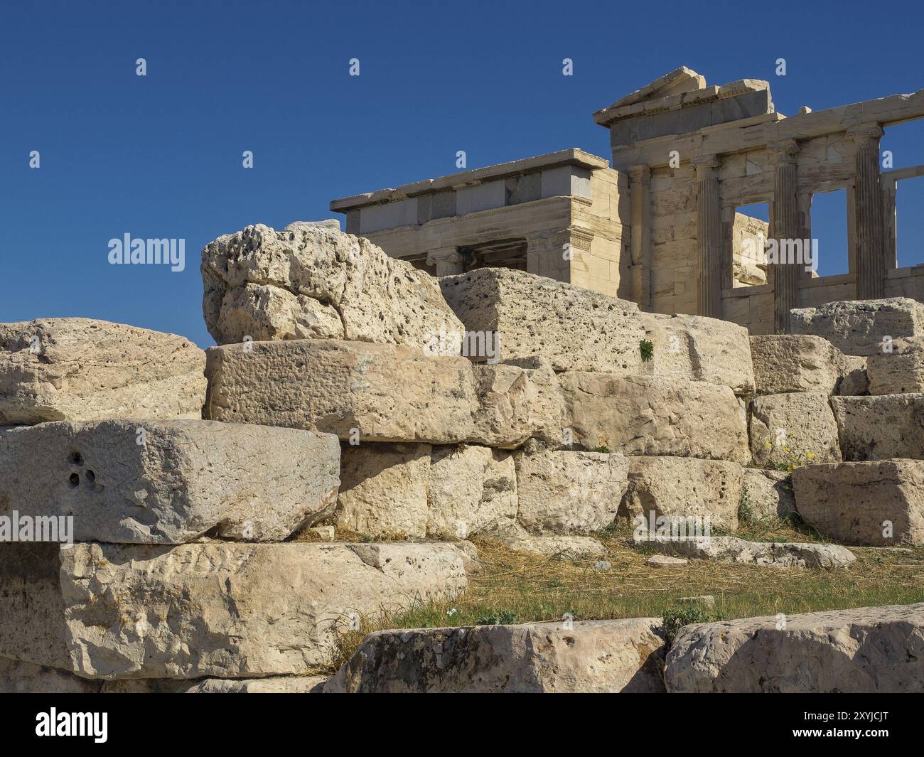Ancient building of large stone blocks standing under a clear blue sky, athens, greece Stock ...