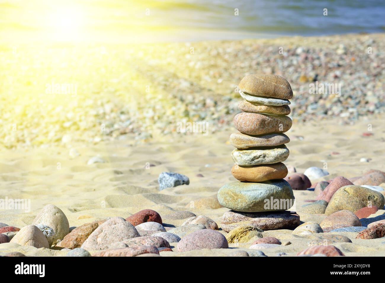 Pyramid of colored pebbles on a Sunny beach Stock Photo - Alamy