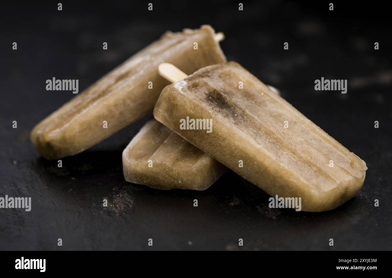 Slate slab with cola popsicles (homemade) as detailed close-up shot ...