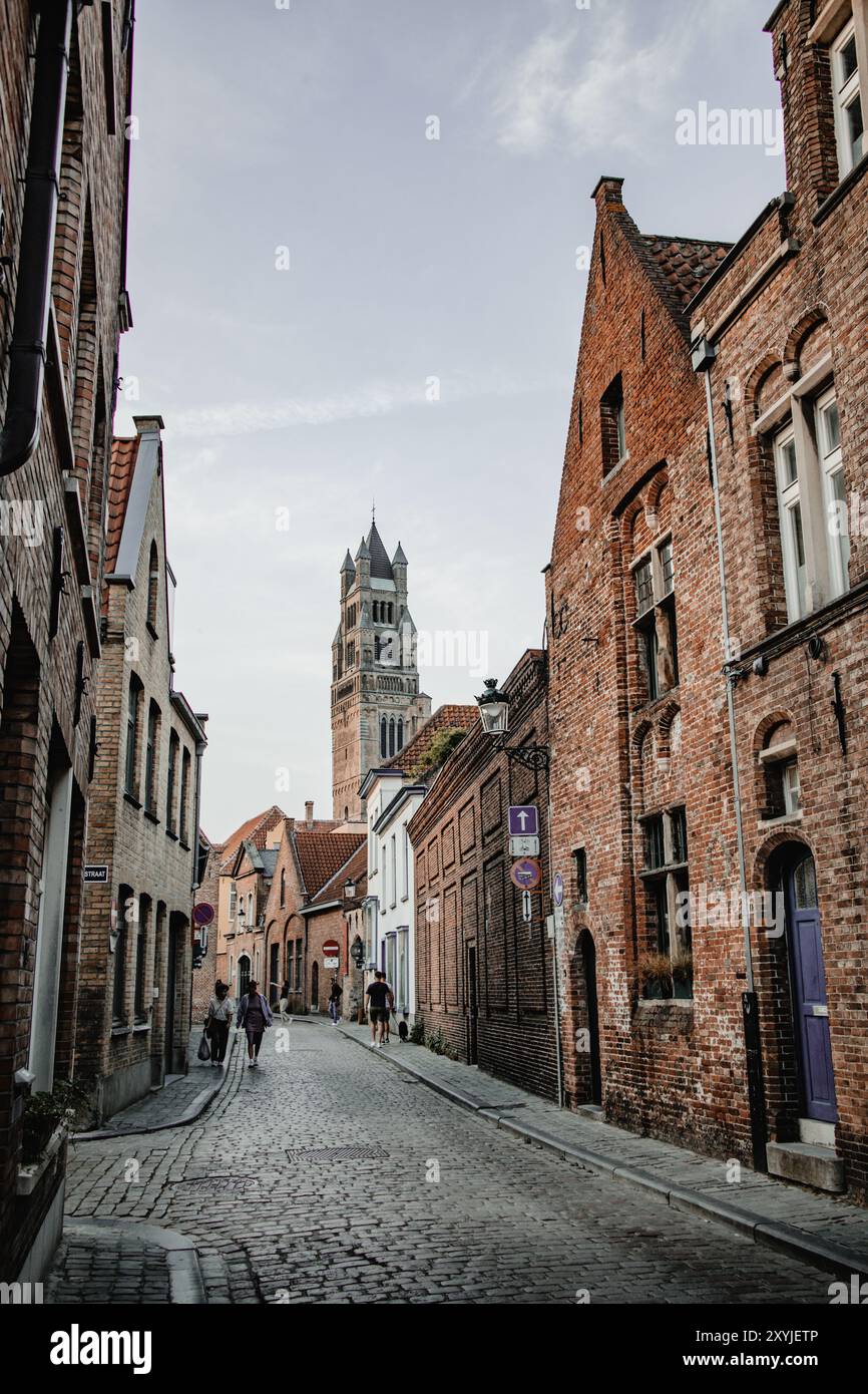A classic street scene with cobbles and houses on Oostmeers in Bruges ...