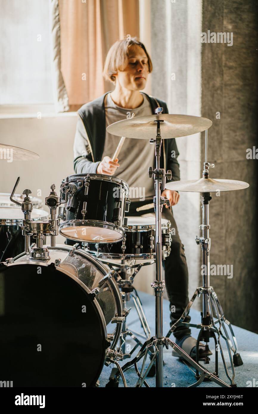 Drummer playing drum set in recording studio. Focused musician ...