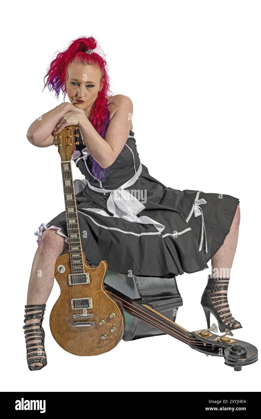 Rock'n'roll singer with red hair sits on a double bass Stock Photo - Alamy