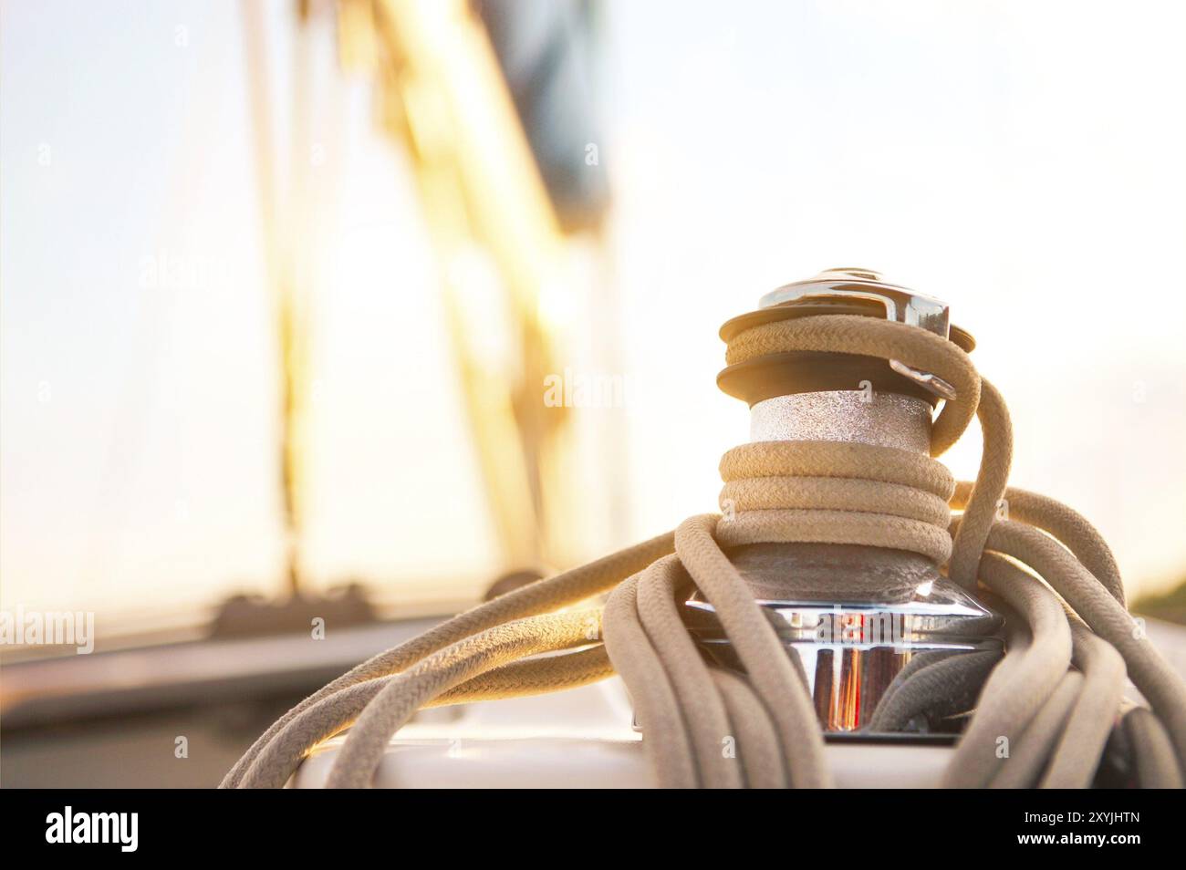 Sailboat detailed parts. Close up on winch and rope of yacht over blue ...