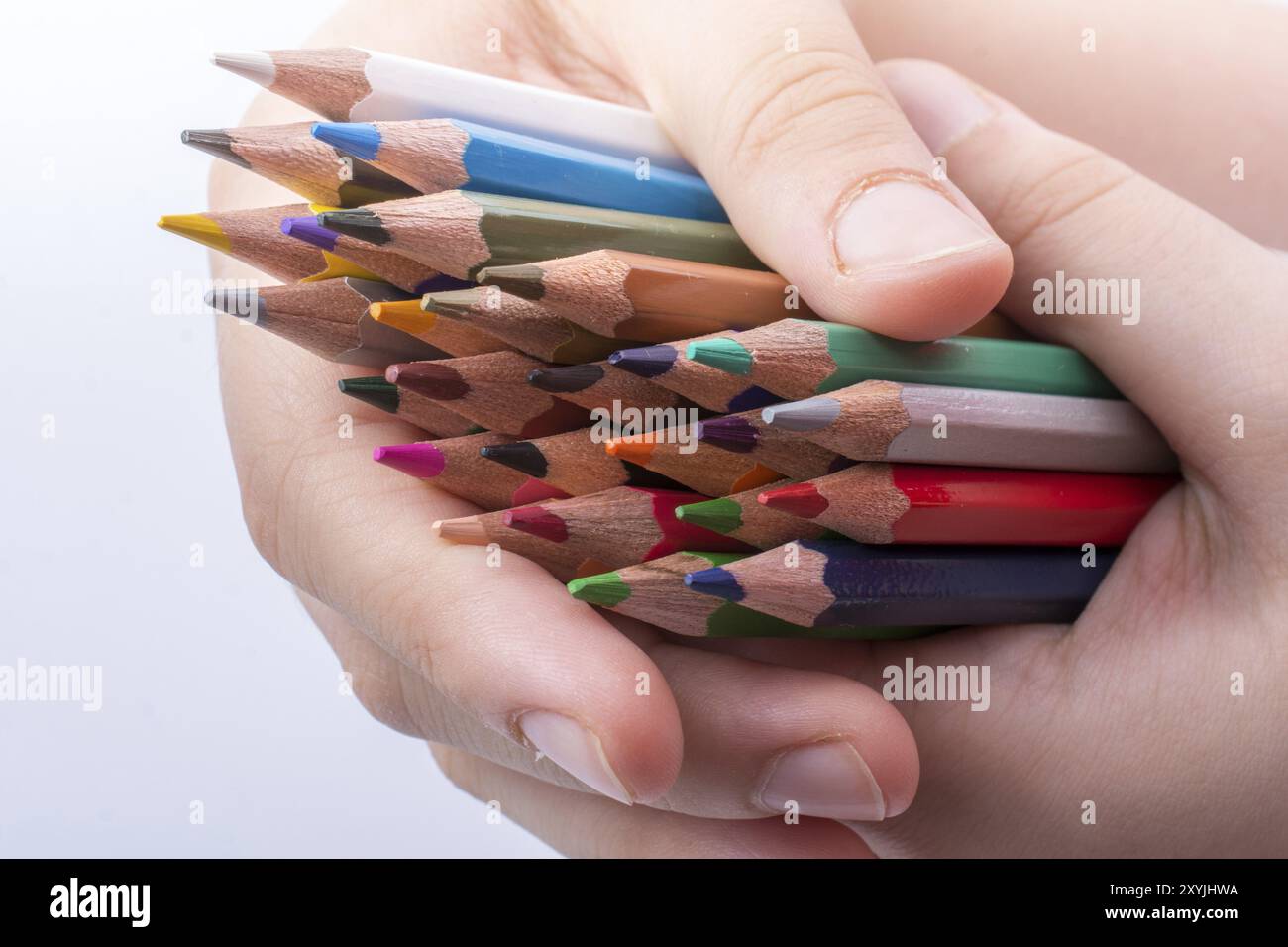 Hand holding color Pencils placed on a white background Stock Photo - Alamy