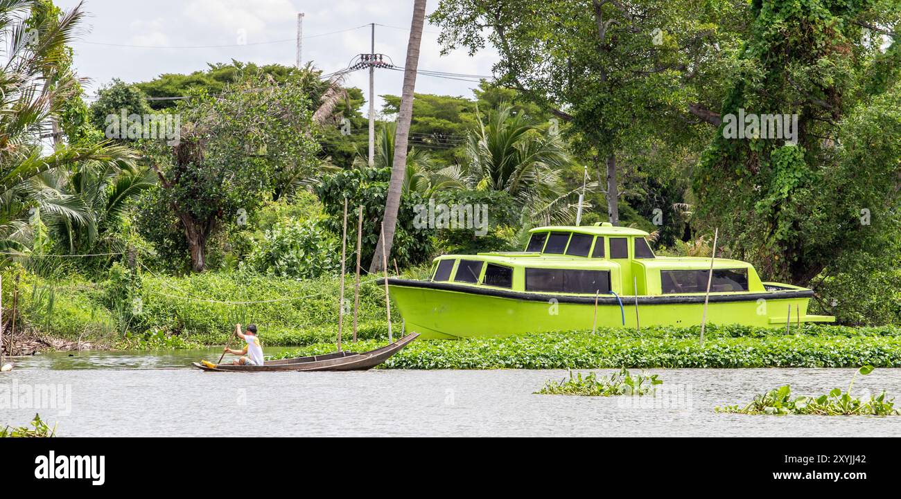 man in boat, green boat Stock Photo - Alamy