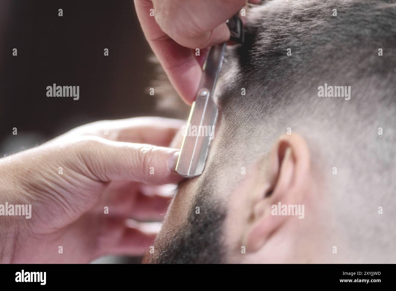 Barber hands close up, shaving head of a bearded man Stock Photo - Alamy