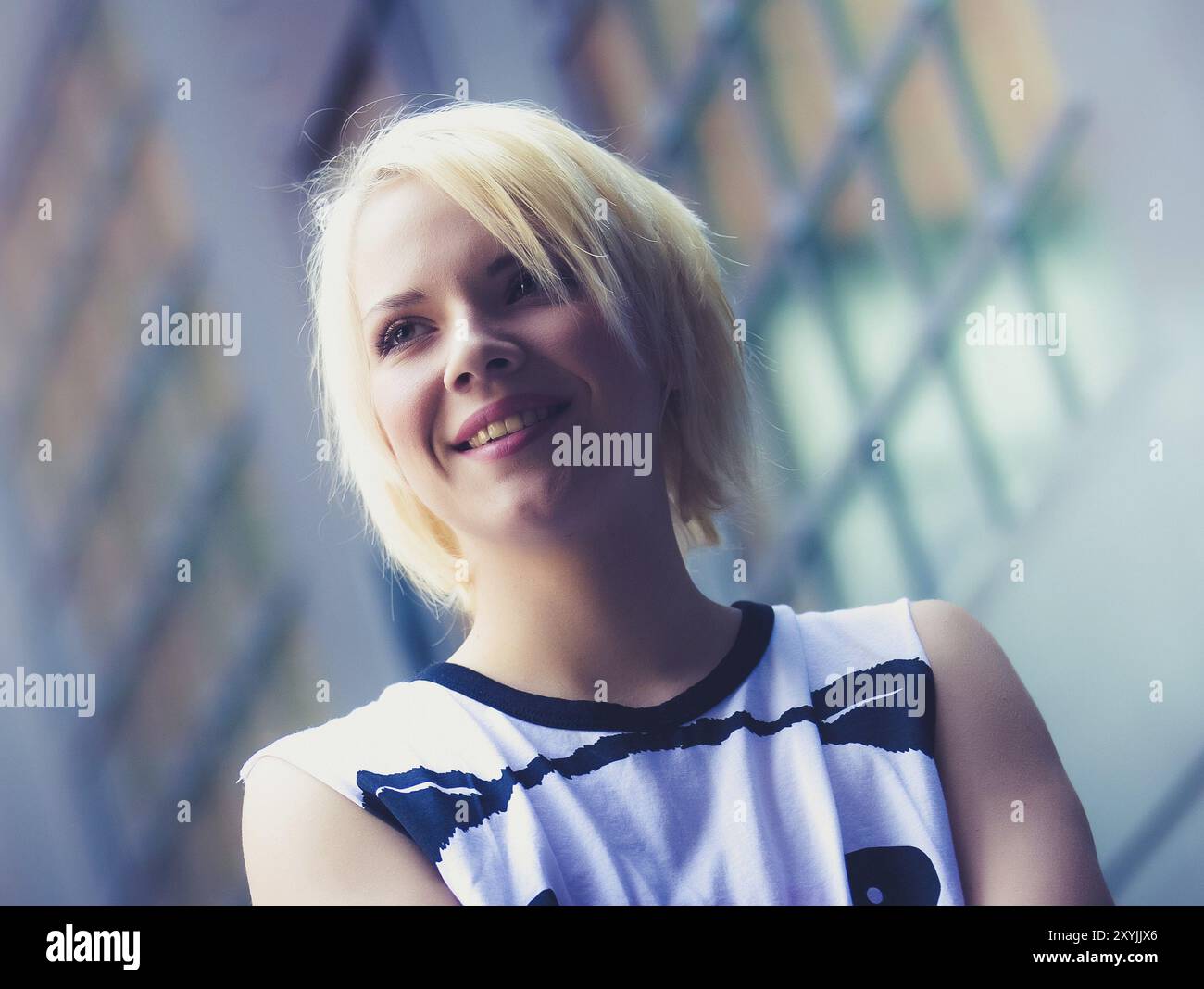 Beautiful young, attractive woman with light blonde hair in an intense ...