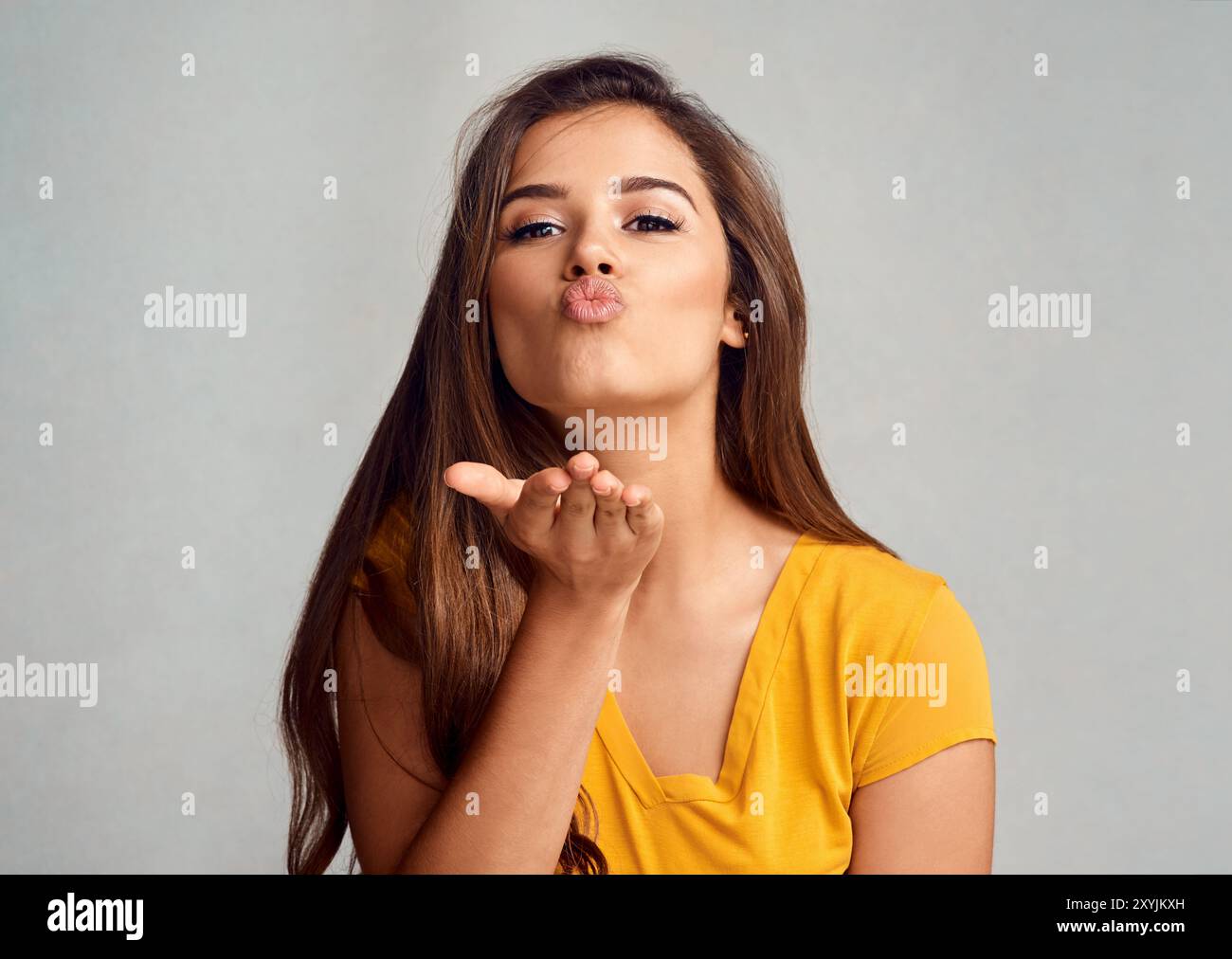 Studio, portrait and woman with blow for kiss, flirting and playful ...