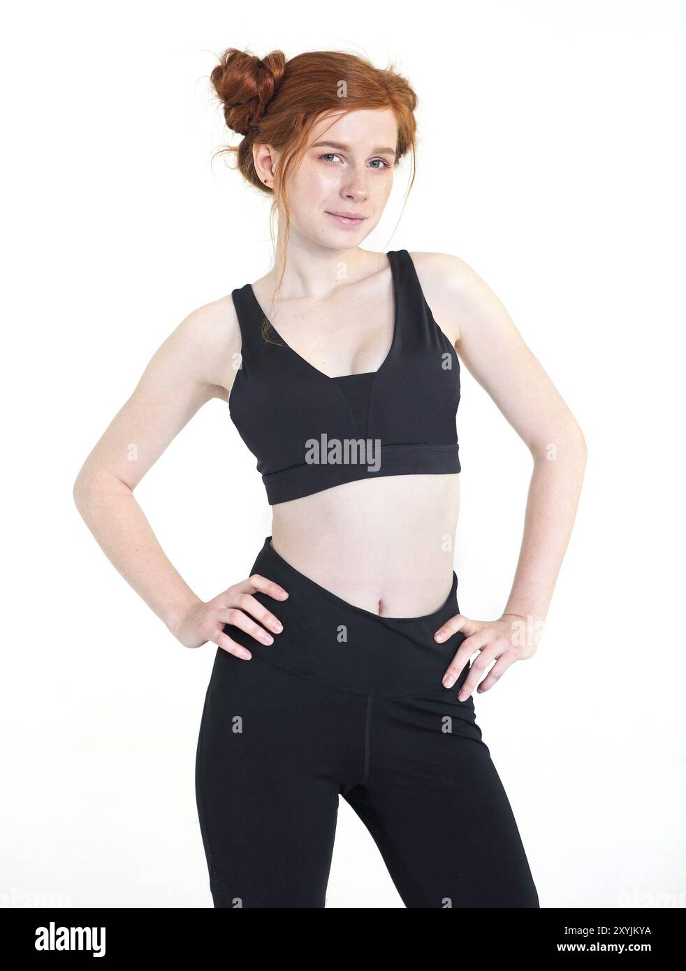 Strong cute redhaired athletic, female runner on the white bacground ...