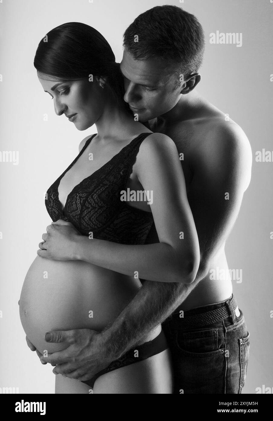 Young man and pretty pregnant woman embrace. Love and family concept Stock Photo - Alamy