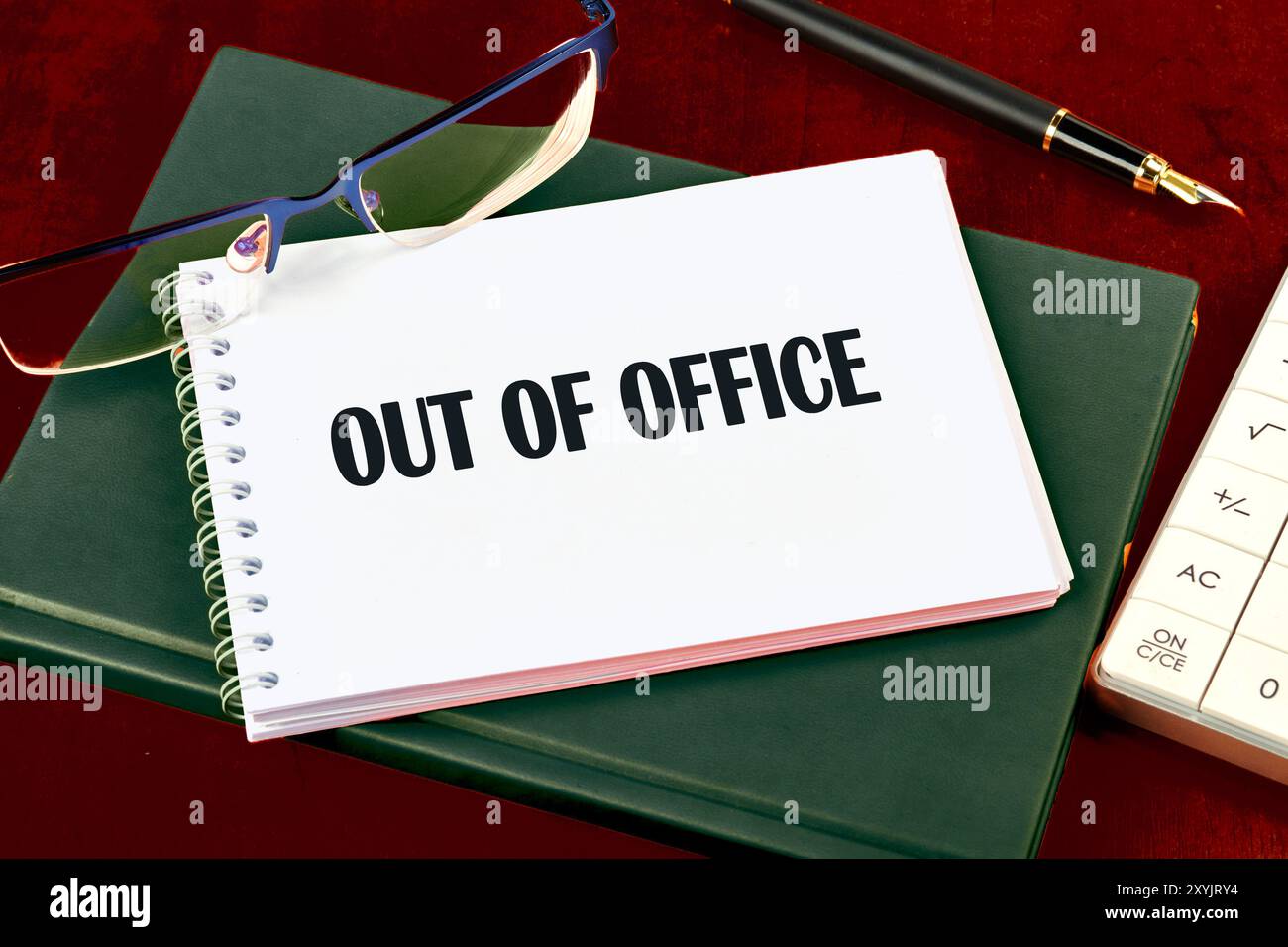 OUT OF OFFICE words written top view in notepad Stock Photo - Alamy
