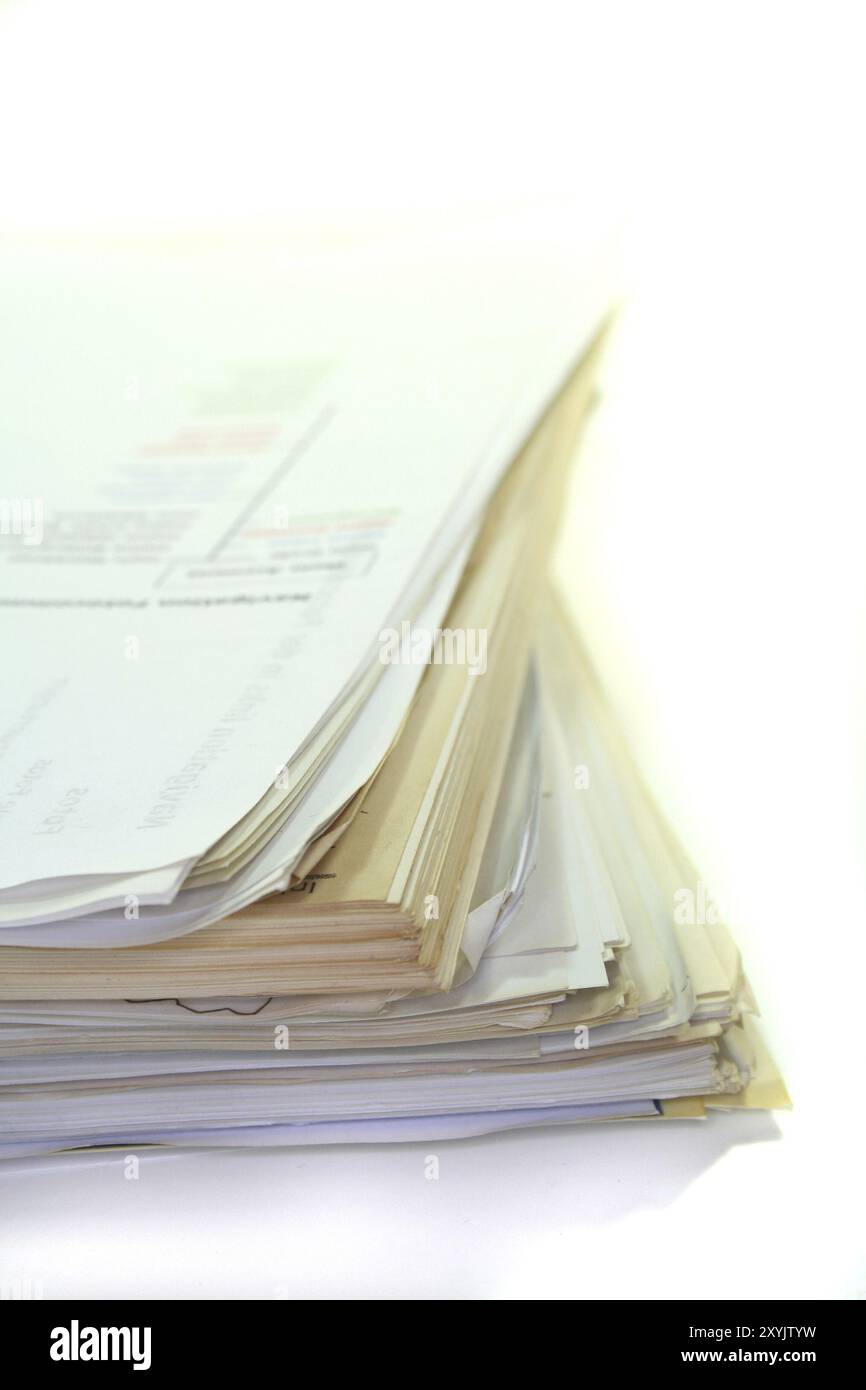 Large pile of papers in front of a white background Stock Photo - Alamy