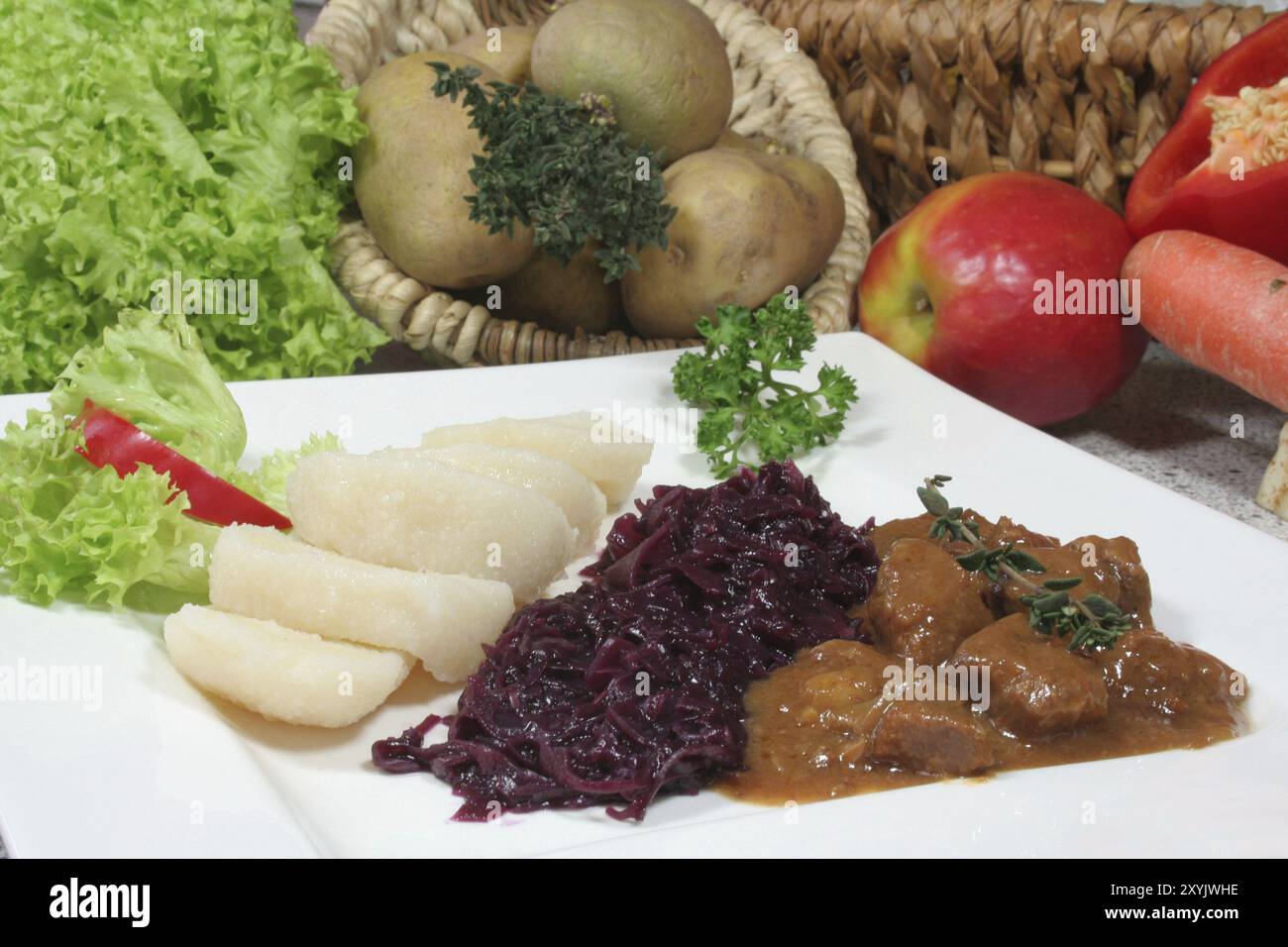 Game goulash with dumplings and red cabbage Stock Photo - Alamy