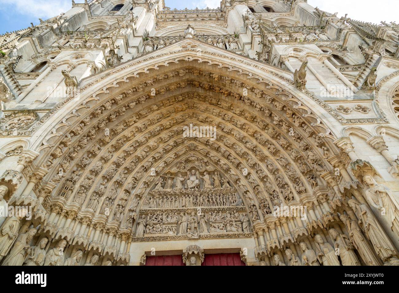 Tympanum of the central west portal showing Gothic sculptures of Christ in Majesty presiding ...