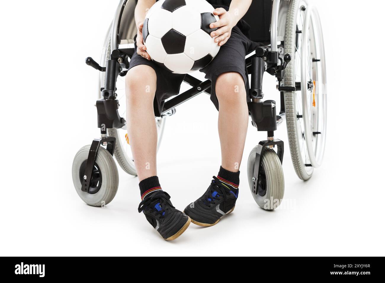 Invalid or disabled child boy sitting on wheelchair hand holding soccer ...