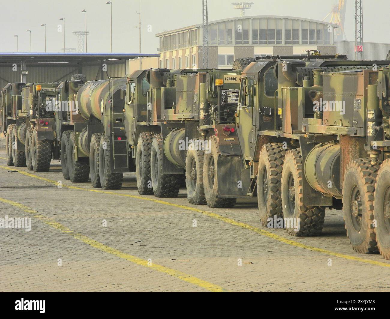 Military trucks parked in a row. Military trucks in a row Stock Photo ...