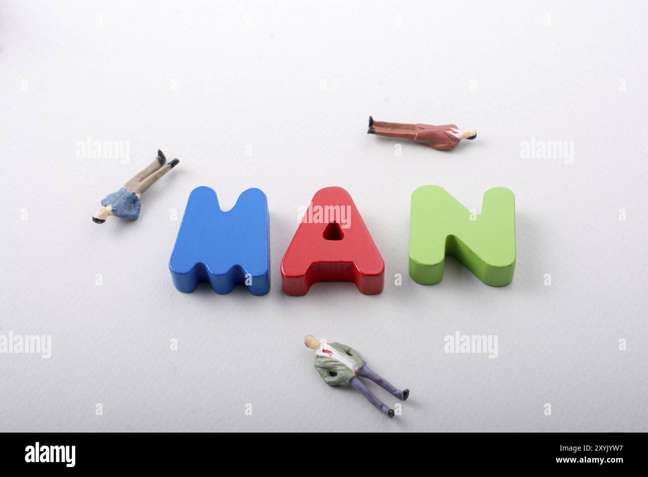 Tiny figurine of men beside colorful wooden letters say MAN Stock Photo ...