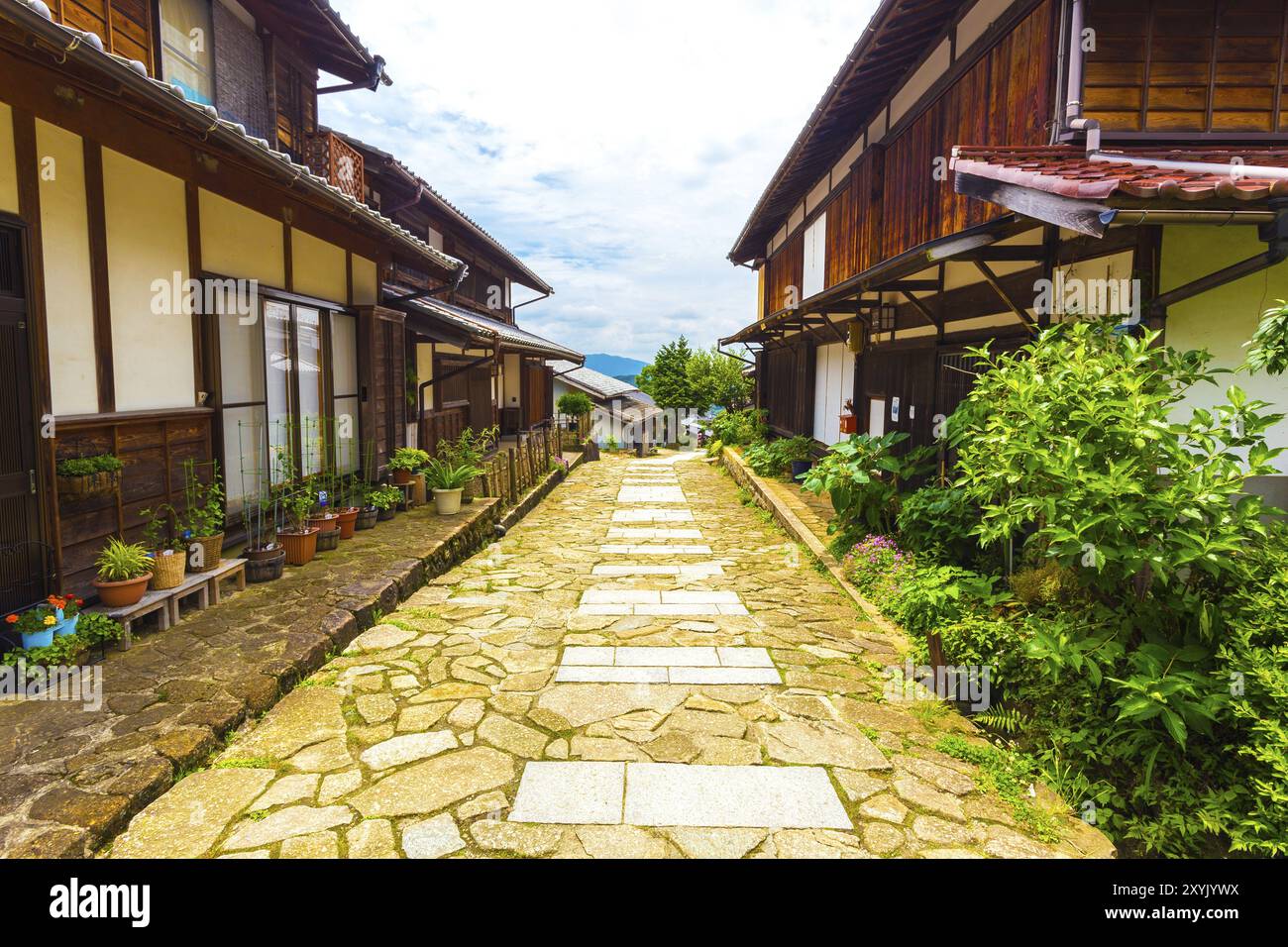 Beautifully restored traditional wooden houses line the sides of a ...