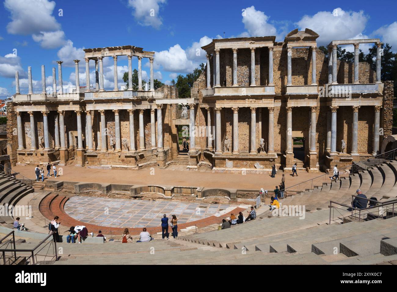 Ancient Roman theatre with stone ruins in the open air, occupied by a ...