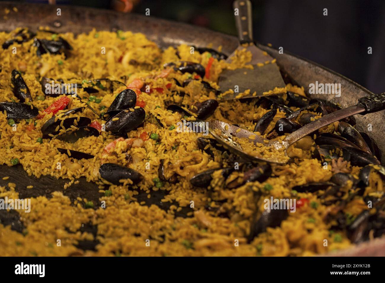 Large pan of seafood paella in a street tray Stock Photo - Alamy
