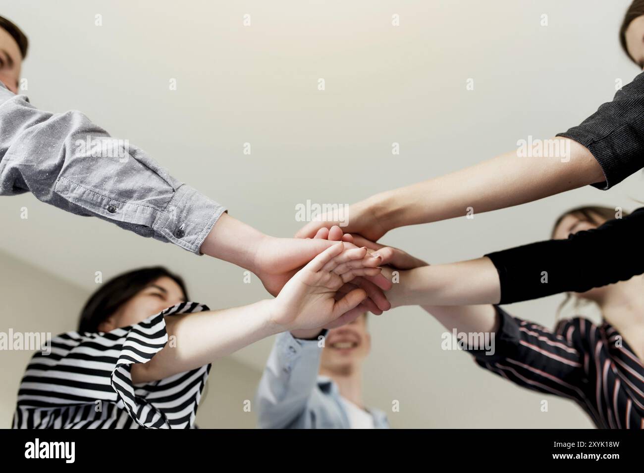 Friendly group of people doing handshake and cross hands. Friendship ...