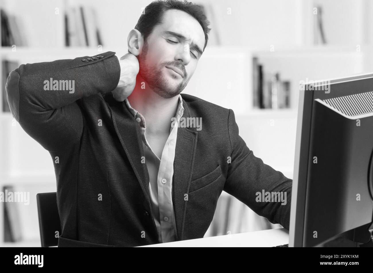 Casual businessman sitting in a desk with pain in his neck, black and ...