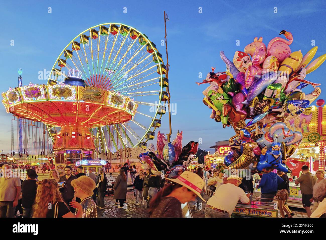 Lots of people at the Cranger Kirmes in front of the Wellenflug and the ...