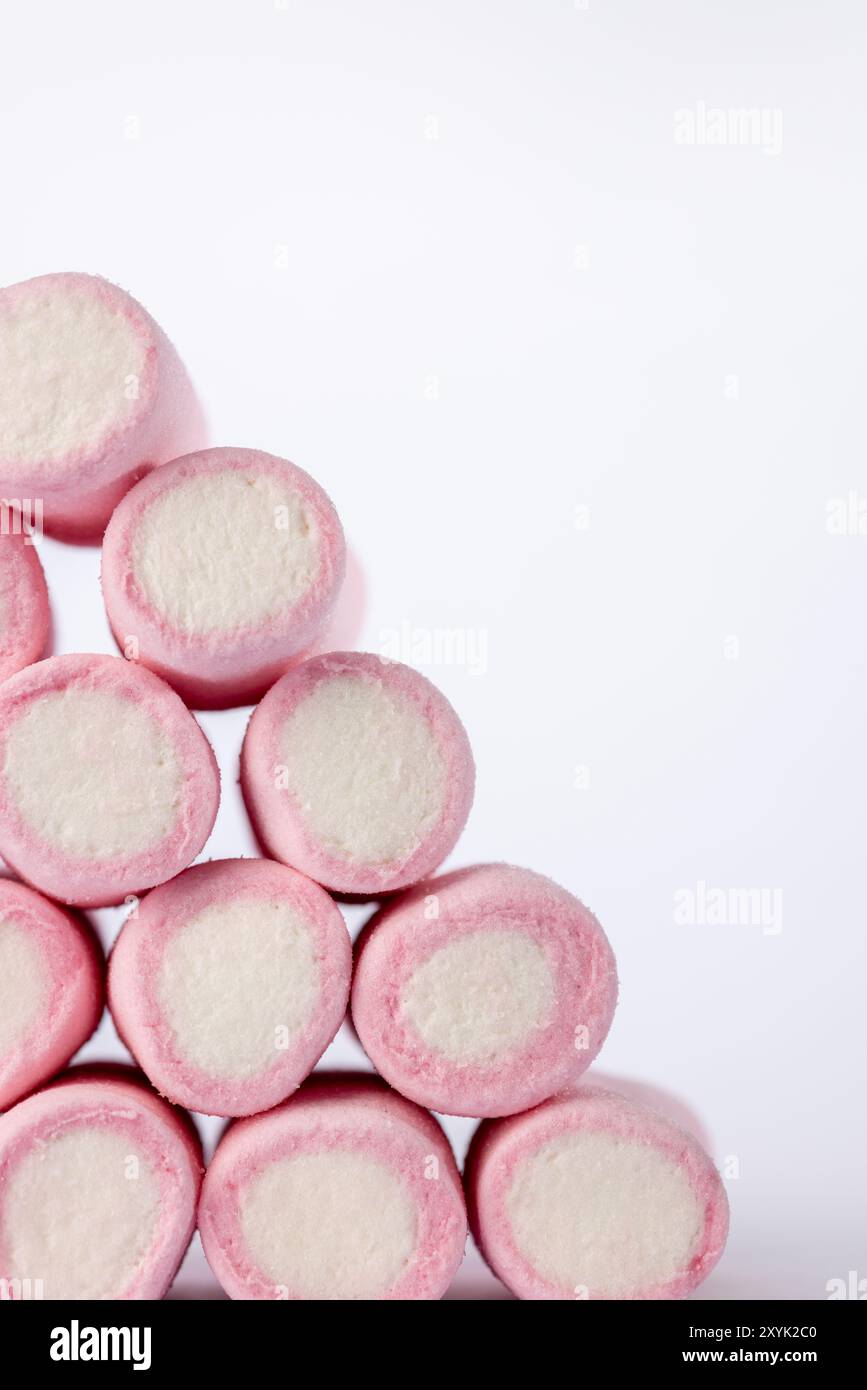 A vertical shot of a marshmallow pyramid stacked on the left side of a ...