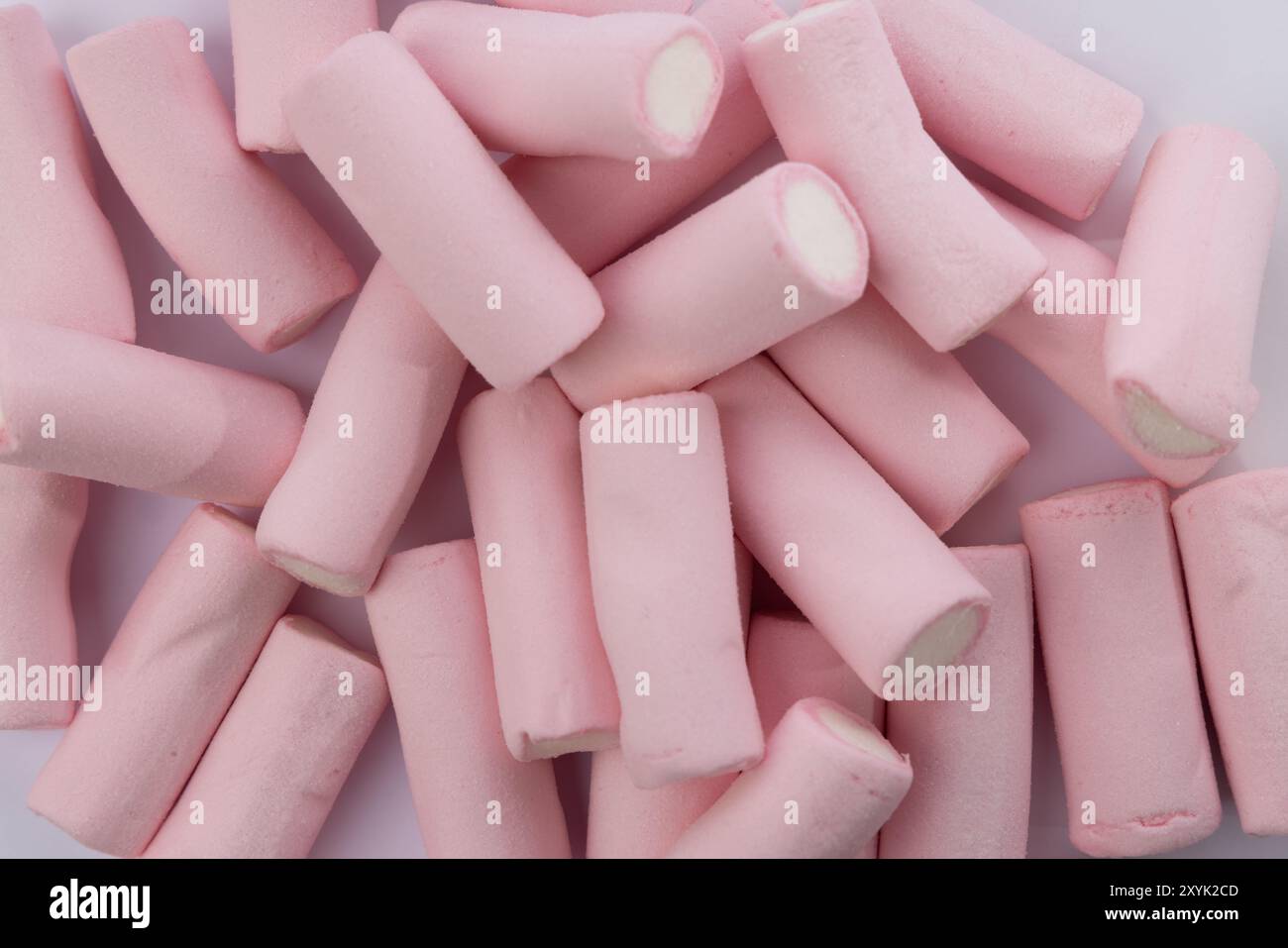 A top view of a messy pile of marshmallows spread out in disarray on a ...