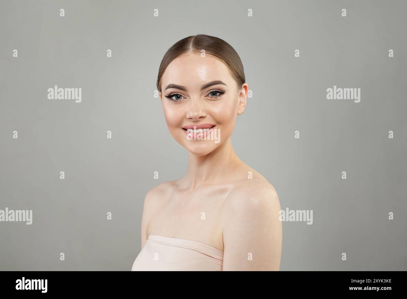 Good-looking happy young female model with natural make-up, shiny clean ...