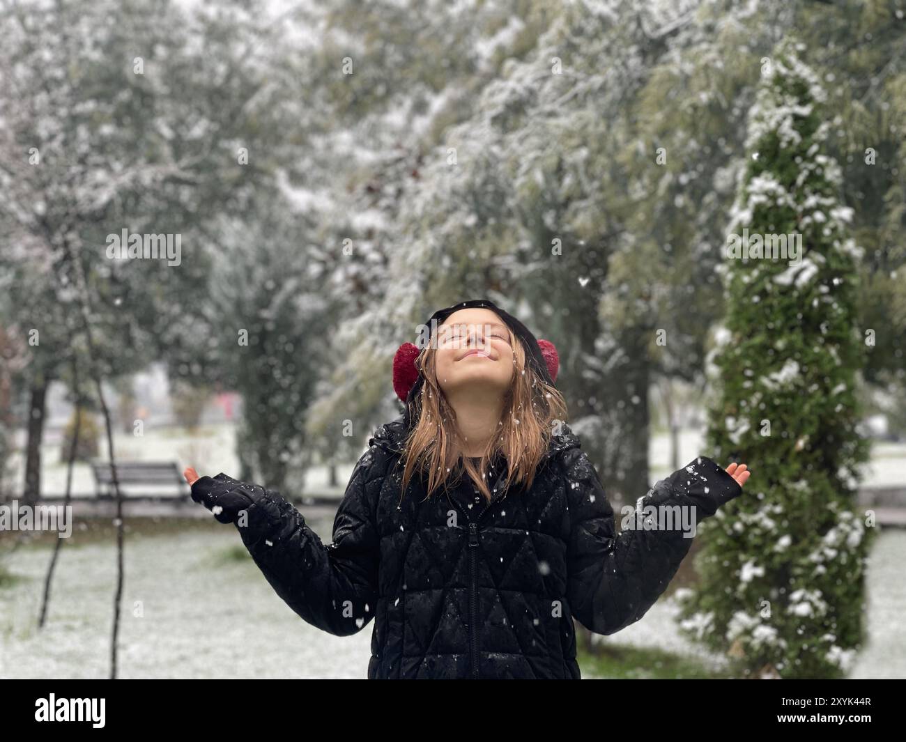 Excited little child girl laughing, walking and enjoying in the snow ...